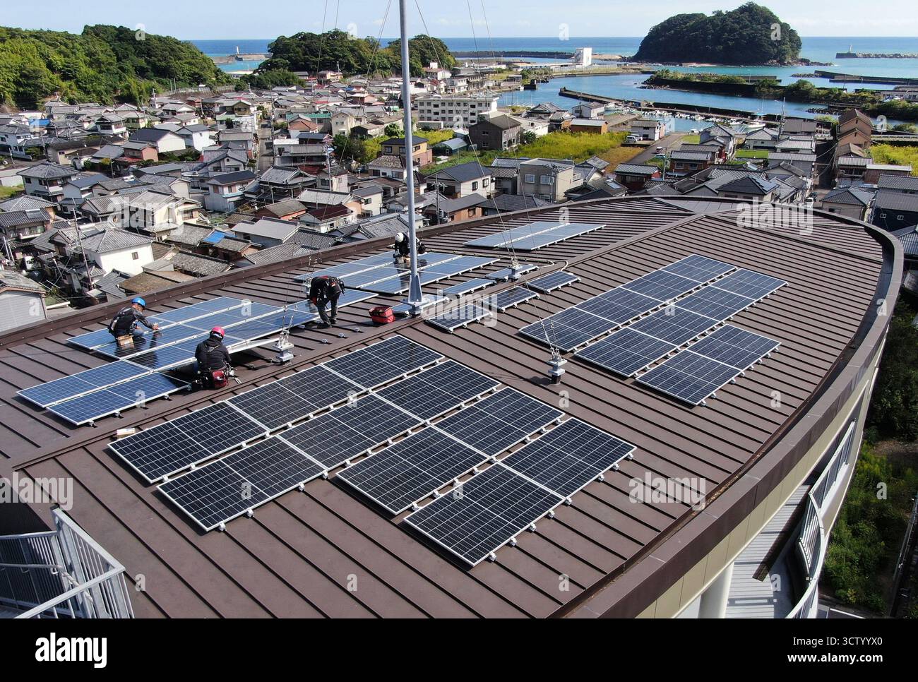 Solar panels are installed on the roof of a tsunami evacuation tower in ...