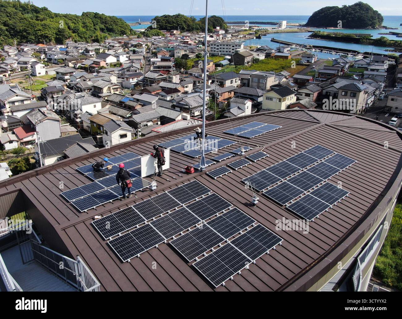 Solar panels are installed on the roof of a tsunami evacuation tower in ...