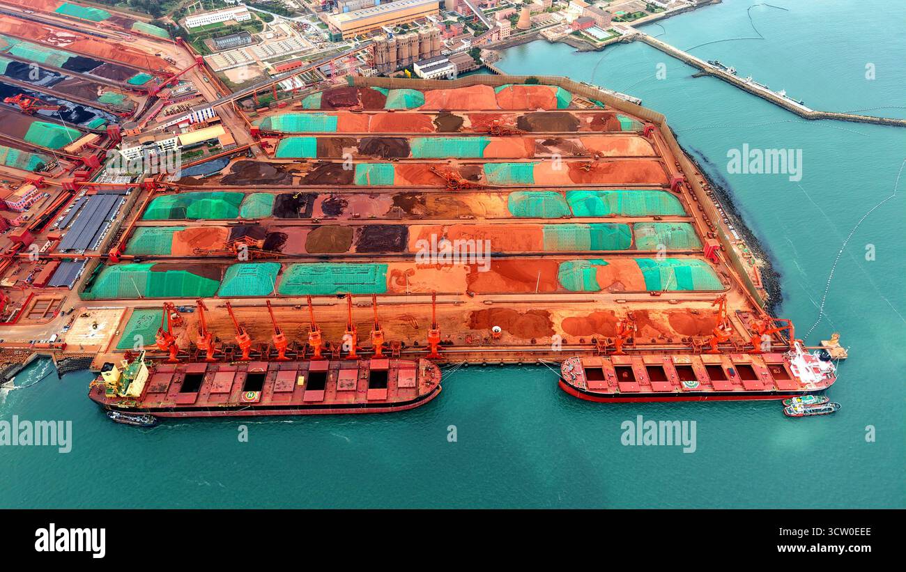 QINGDAO, CHINA - OCTOBER 9, 2025 - A cargo ship unloads imported iron ...