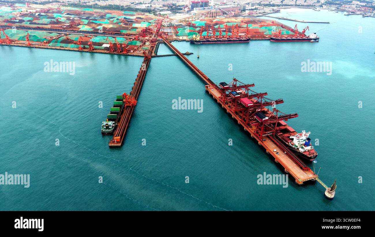 QINGDAO, CHINA - OCTOBER 9, 2025 - A cargo ship unloads imported iron ...