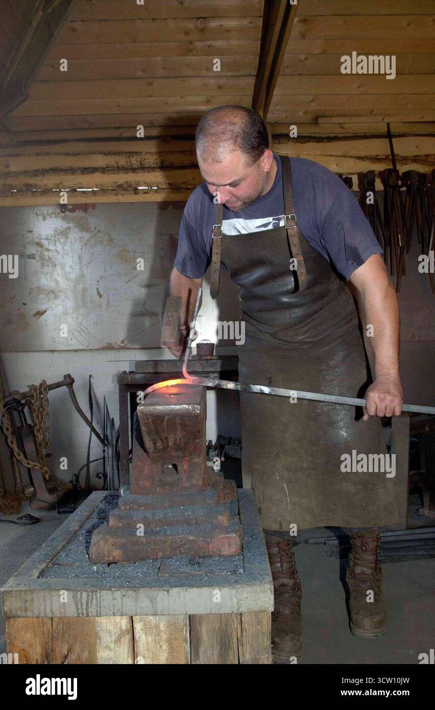 anvil and hammer in a forge, tools of a blacksmith anvil and hammer in ...