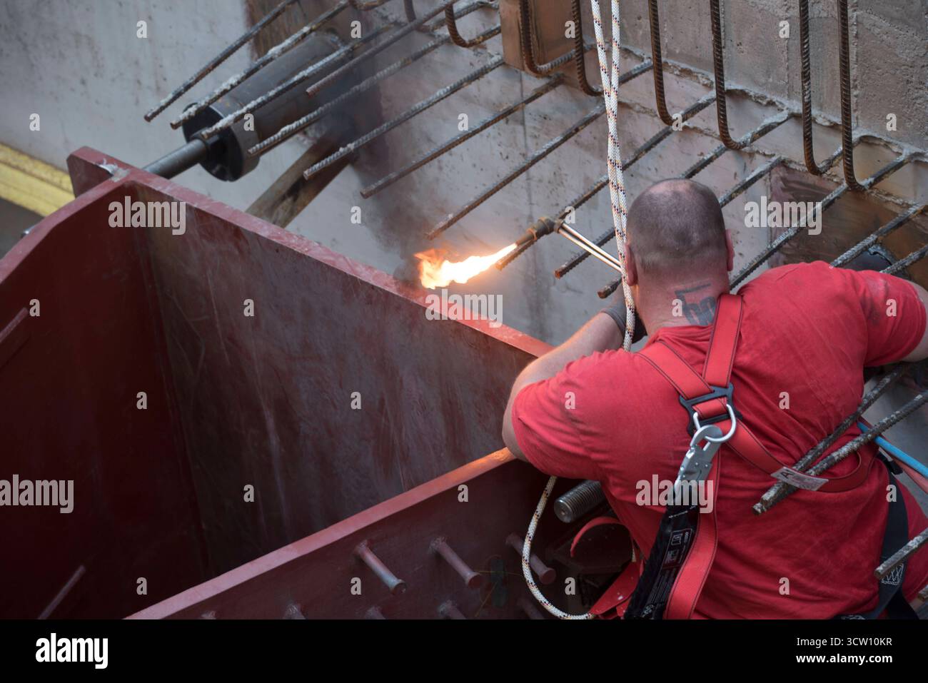 a metal worker is welding a pipe in protective clothing worker welding ...