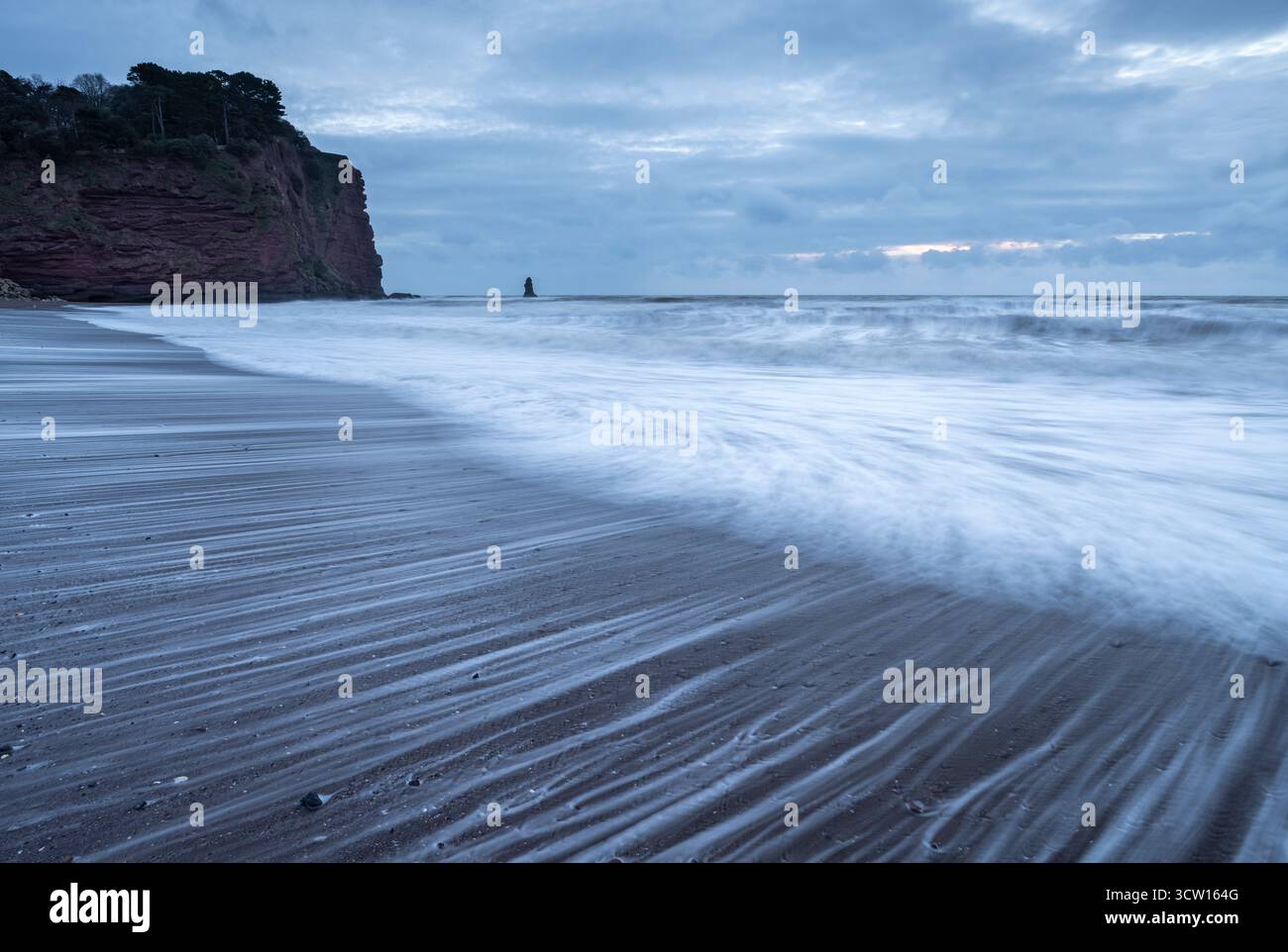 Stormy sunrise on Holcombe Beach in Teignmouth, Devon, England. Winter ...
