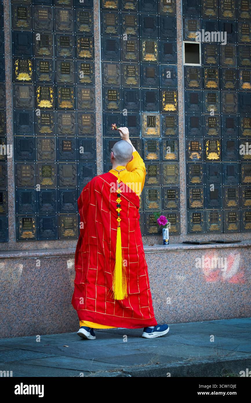 At an An Ling ceremony a Buddhist monk sprinkles water on a columbarium ...