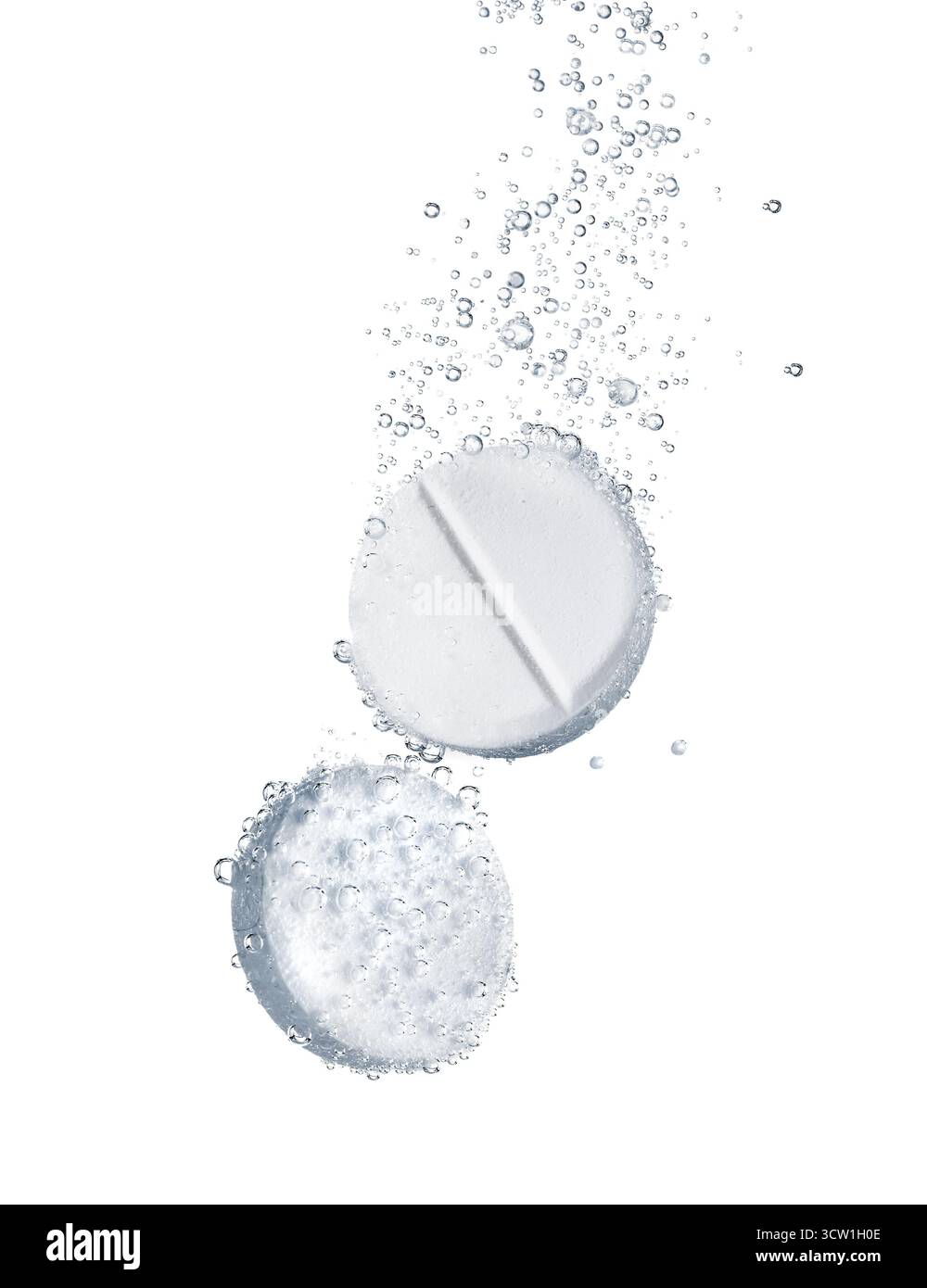 Two effervescent tablets fizz and dissolve on a white background ...