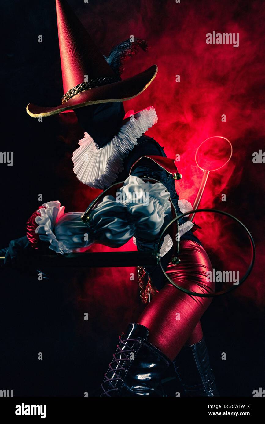 Dynamic profile shot of a mysterious jester or harlequin figure in a ...