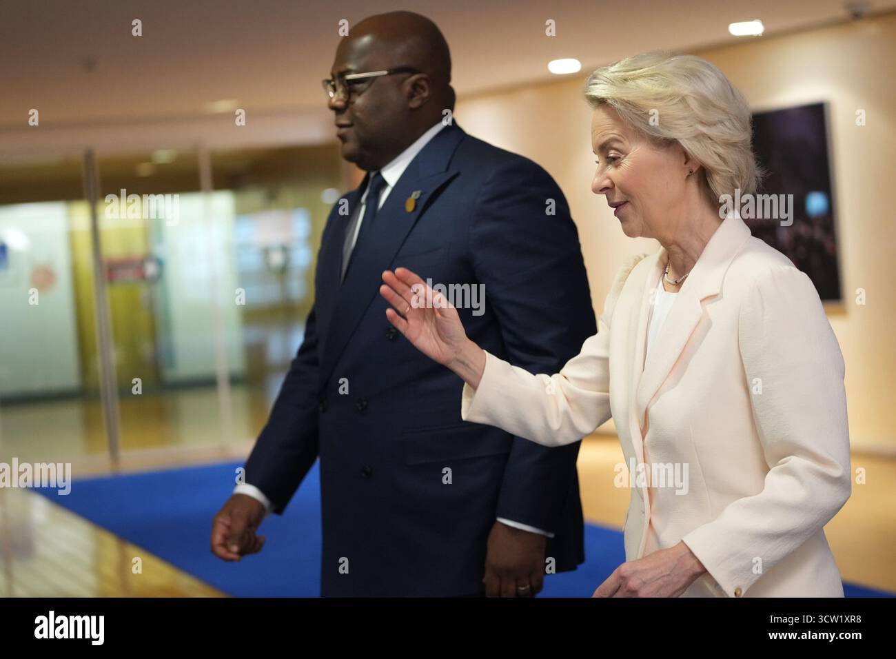 European Commission President Ursula von der Leyen, right, walks with ...