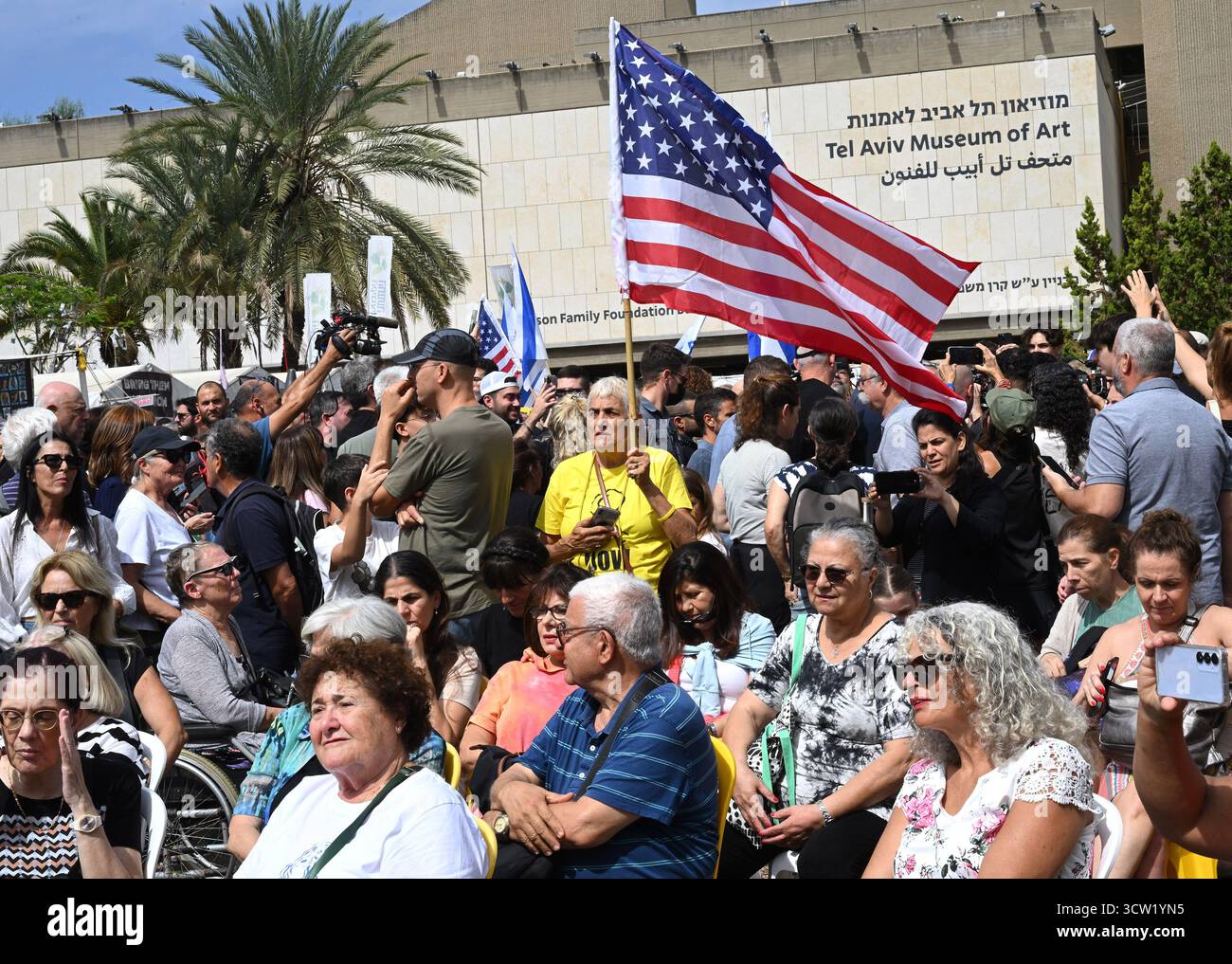 Tel Aviv, Israel. 09th Oct, 2025. A woman holds an American flag as ...
