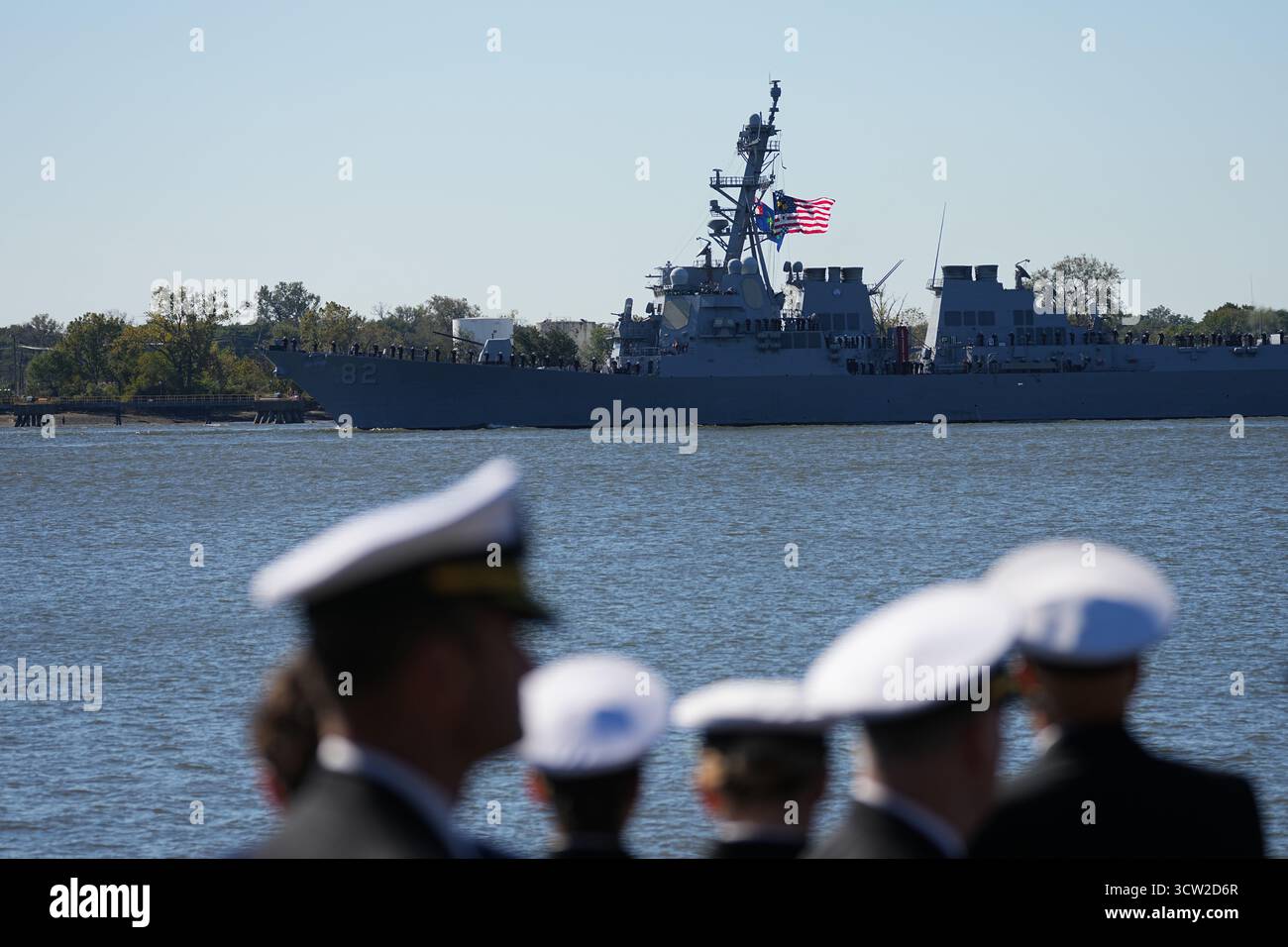 Spectators look on as USS Lassen passes the viewing stand during the ...