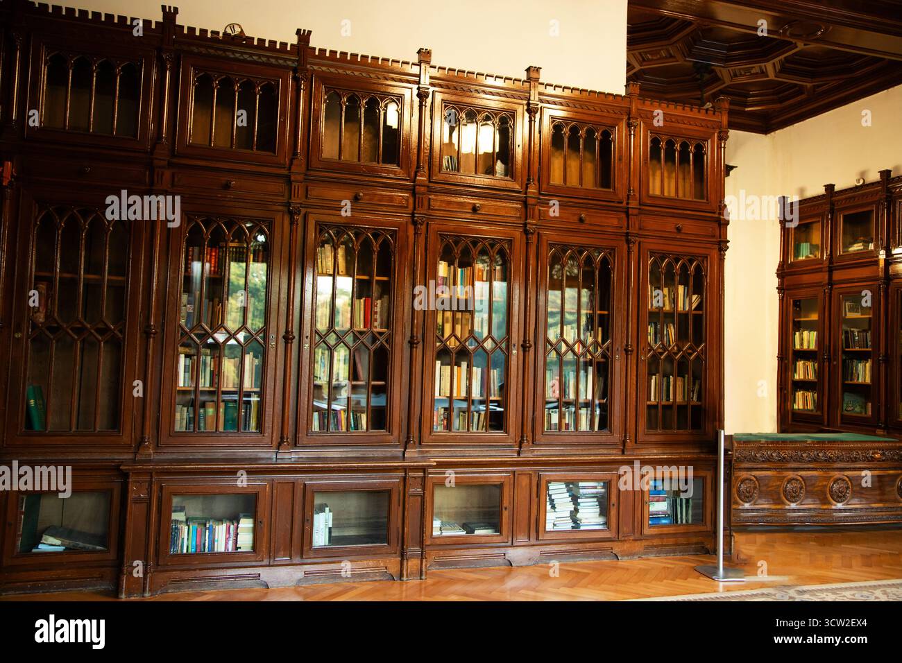 Vintage library interior with a large antique wooden bookshelf filled ...