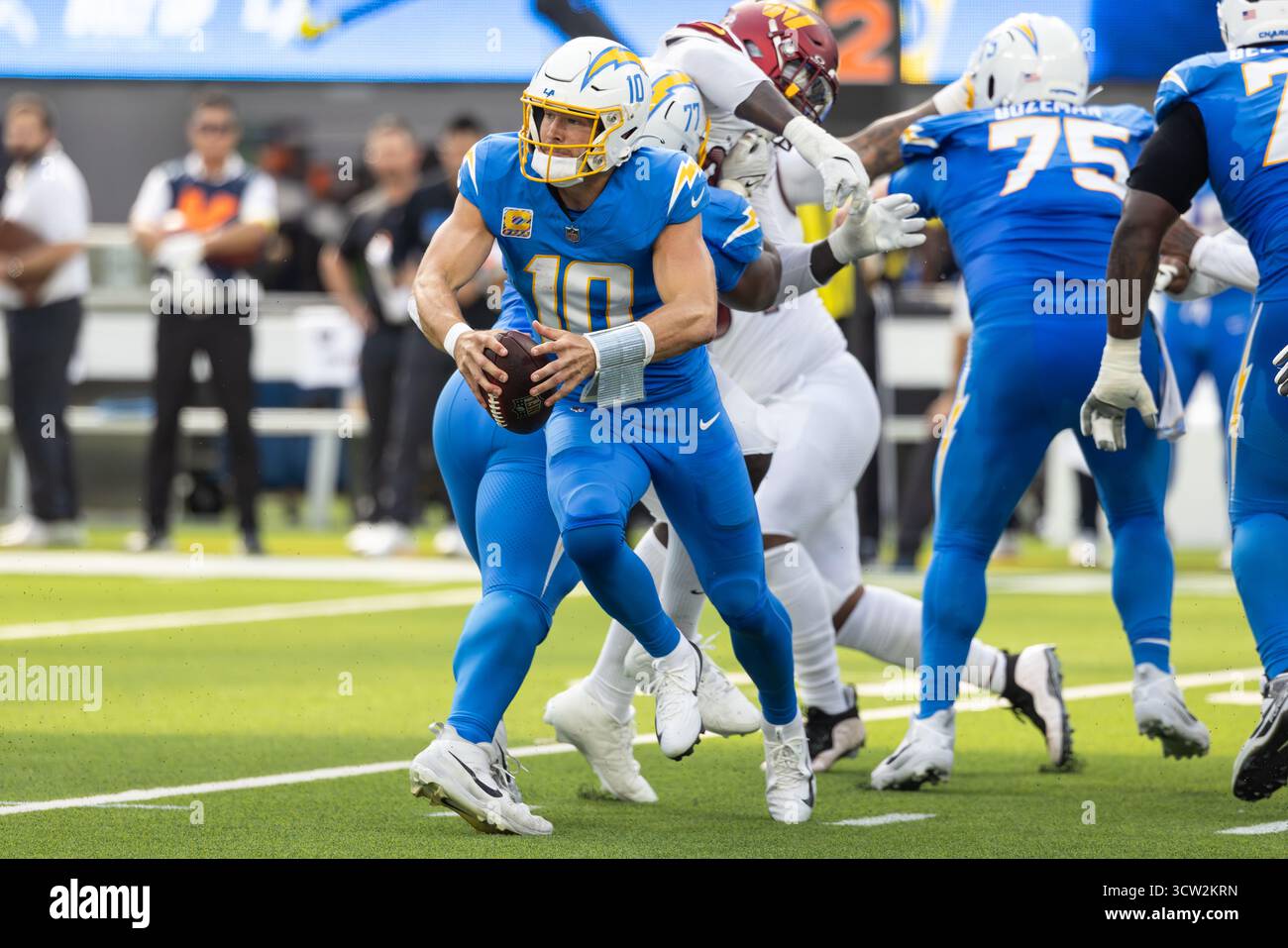 Los Angeles Chargers quarterback Justin Herbert (10) scrambles out of ...