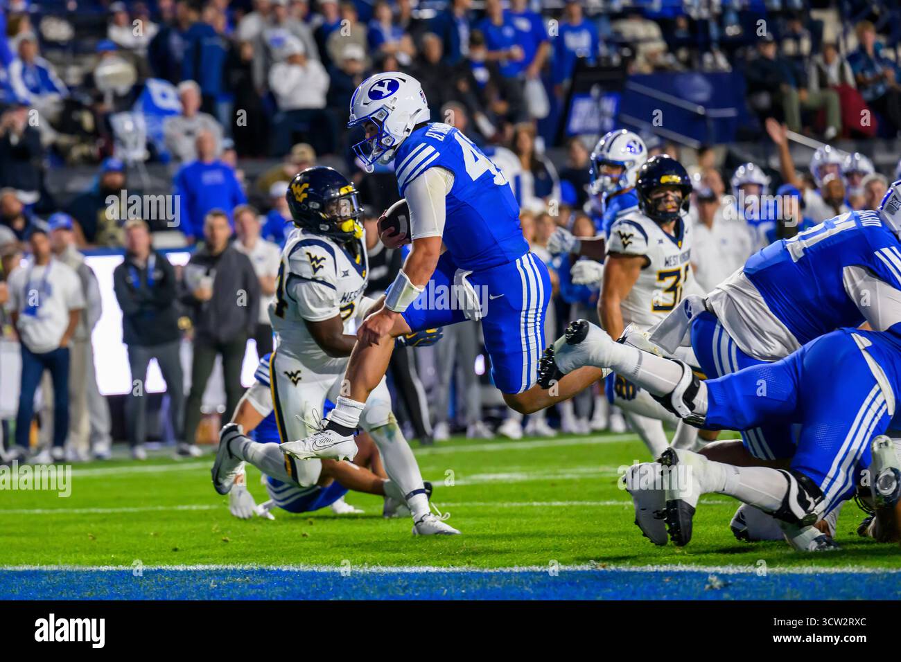 BYU quarterback Bear Bachmeier (47) leaps into the endzone during the ...