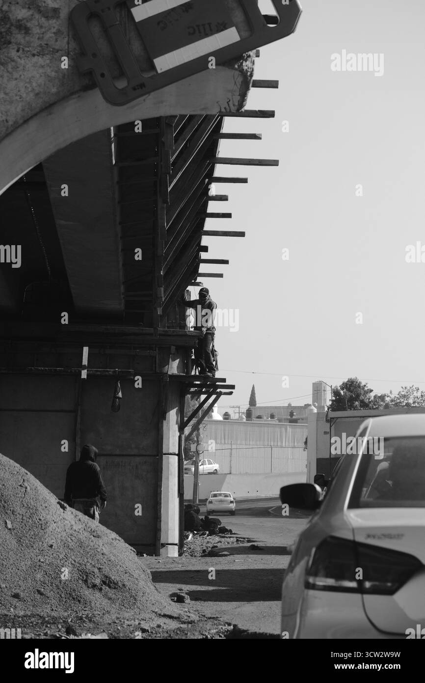 Construction workers building housing Black and White Stock Photos ...