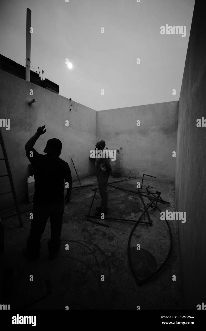 Construction workers building housing Black and White Stock Photos ...