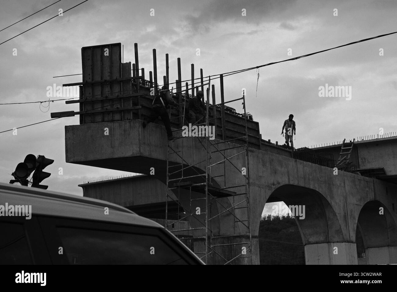 Construction workers building housing Black and White Stock Photos ...