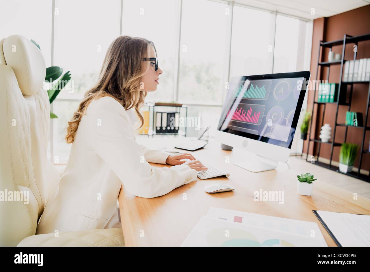 Businesswoman in elegant attire working diligently in a modern office ...