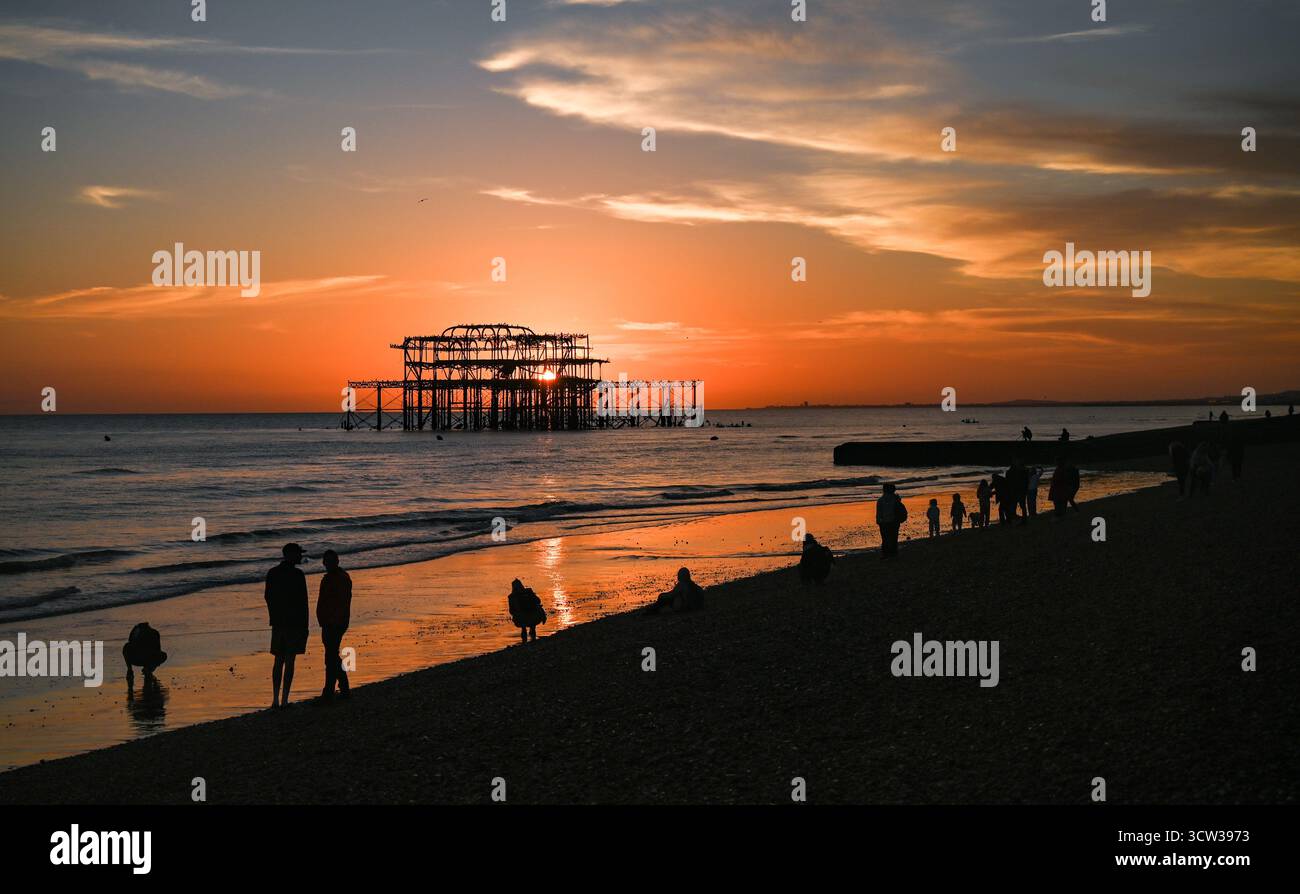 Brighton UK 9th October 2025 - Visitors enjoy a beautiful sunset over ...