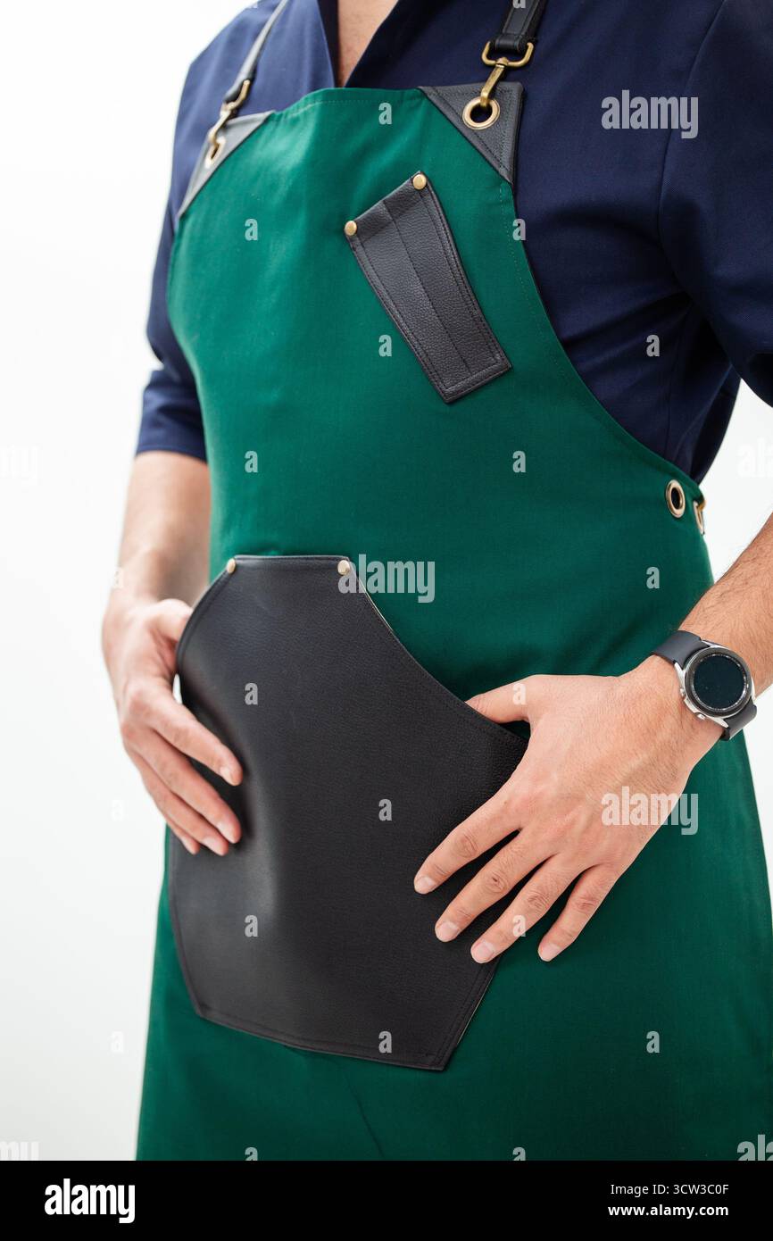 Man in green apron with leather pocket - style, practicality and ...