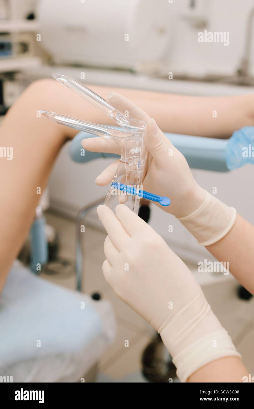 Gynecologist prepares speculum and brush for cervical screening. Close ...