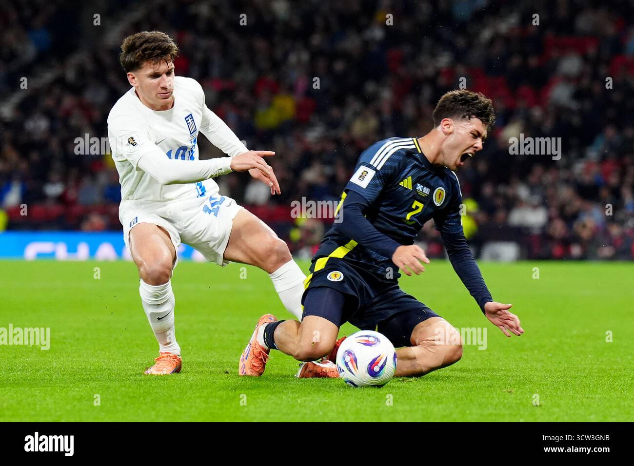 Greece's Christos Tzolis (left) fouls Scotland's Aaron Hickey (right ...