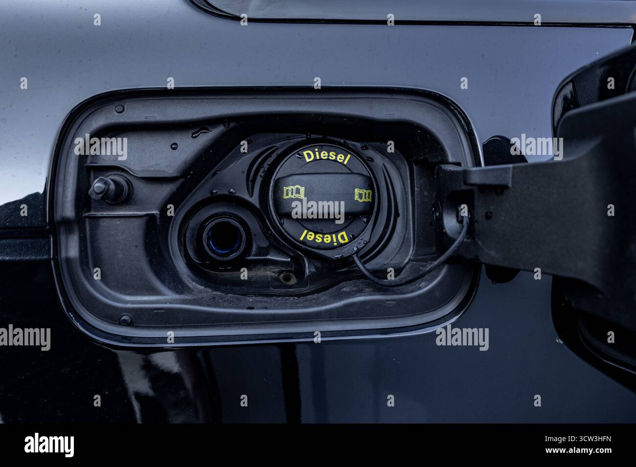 Close-up of a car’s fuel filler area showing diesel and AdBlue caps ...