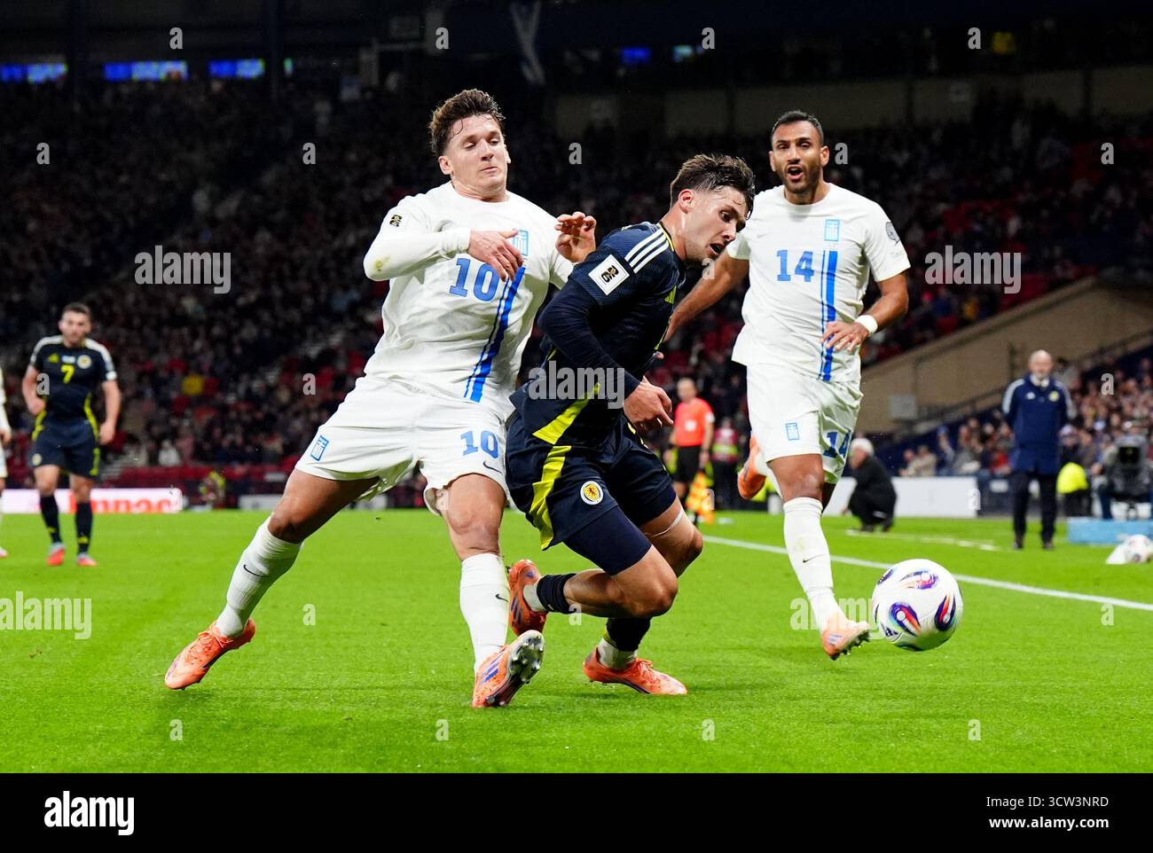 Greece's Christos Tzolis (left) fouls Scotland's Aaron Hickey (centre ...
