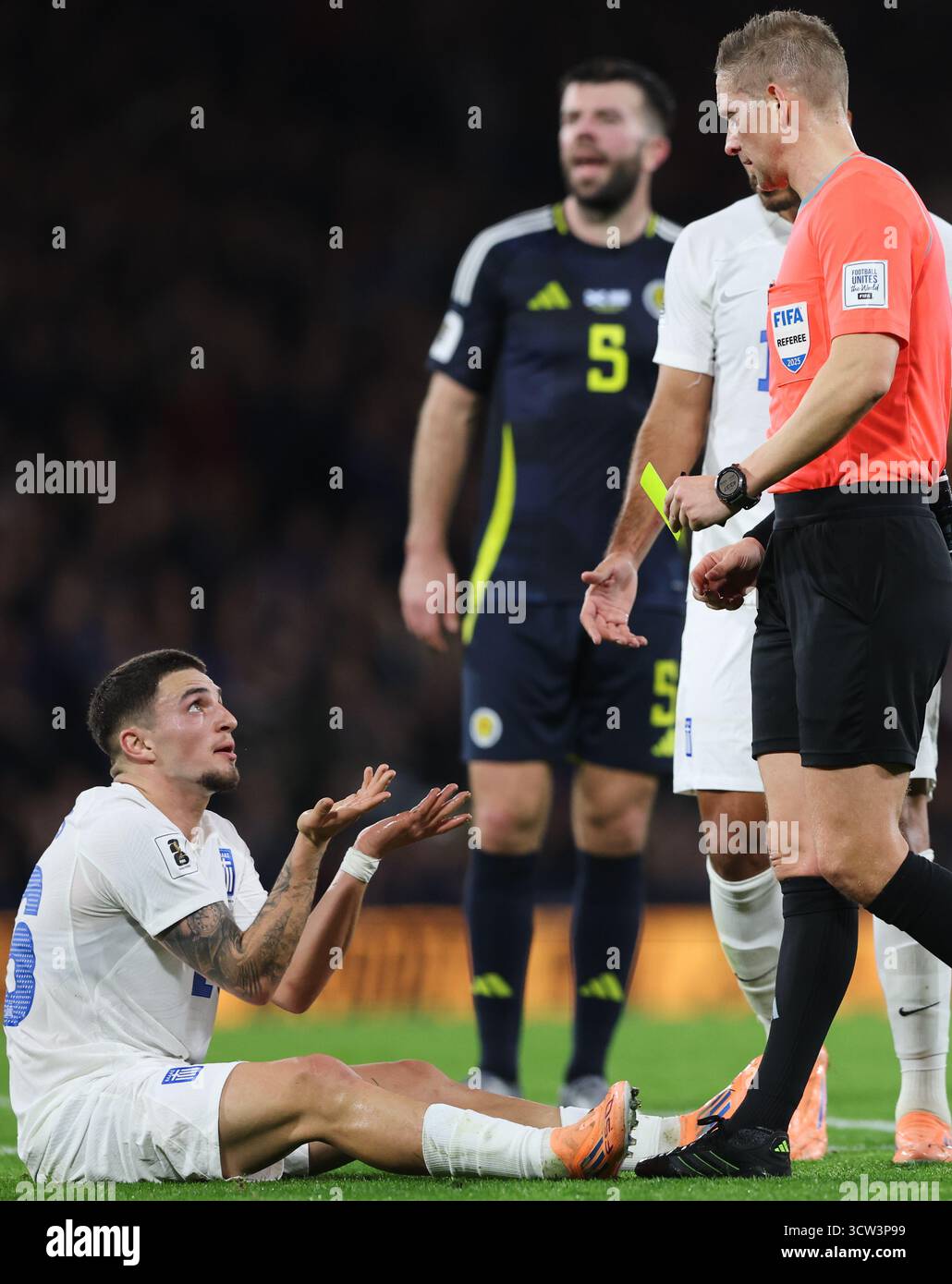 Referee Espen Eskas shows the yellow card to Greece's Christos Zafeiris ...