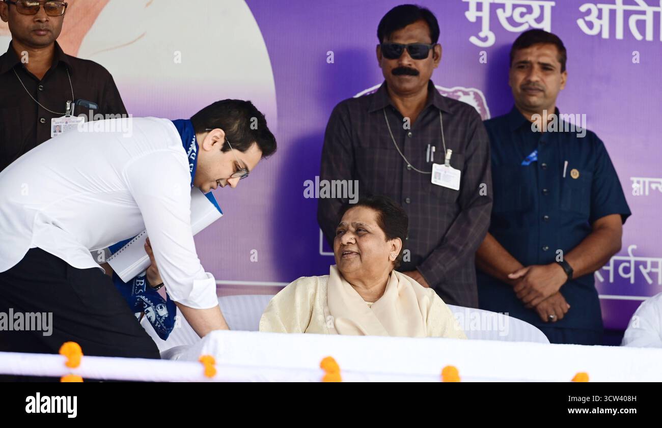 LUCKNOW, INDIA - OCTOBER 9: Akash Anand touches the feet of BSP supremo ...
