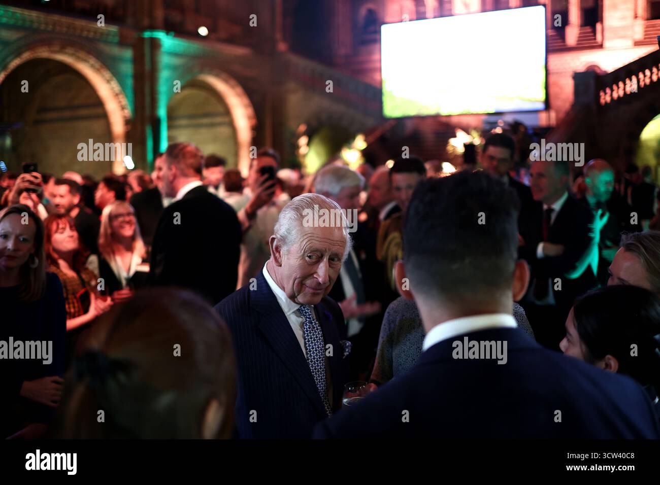 King Charles III speaks with guests during the Countdown to Cop30 event ...