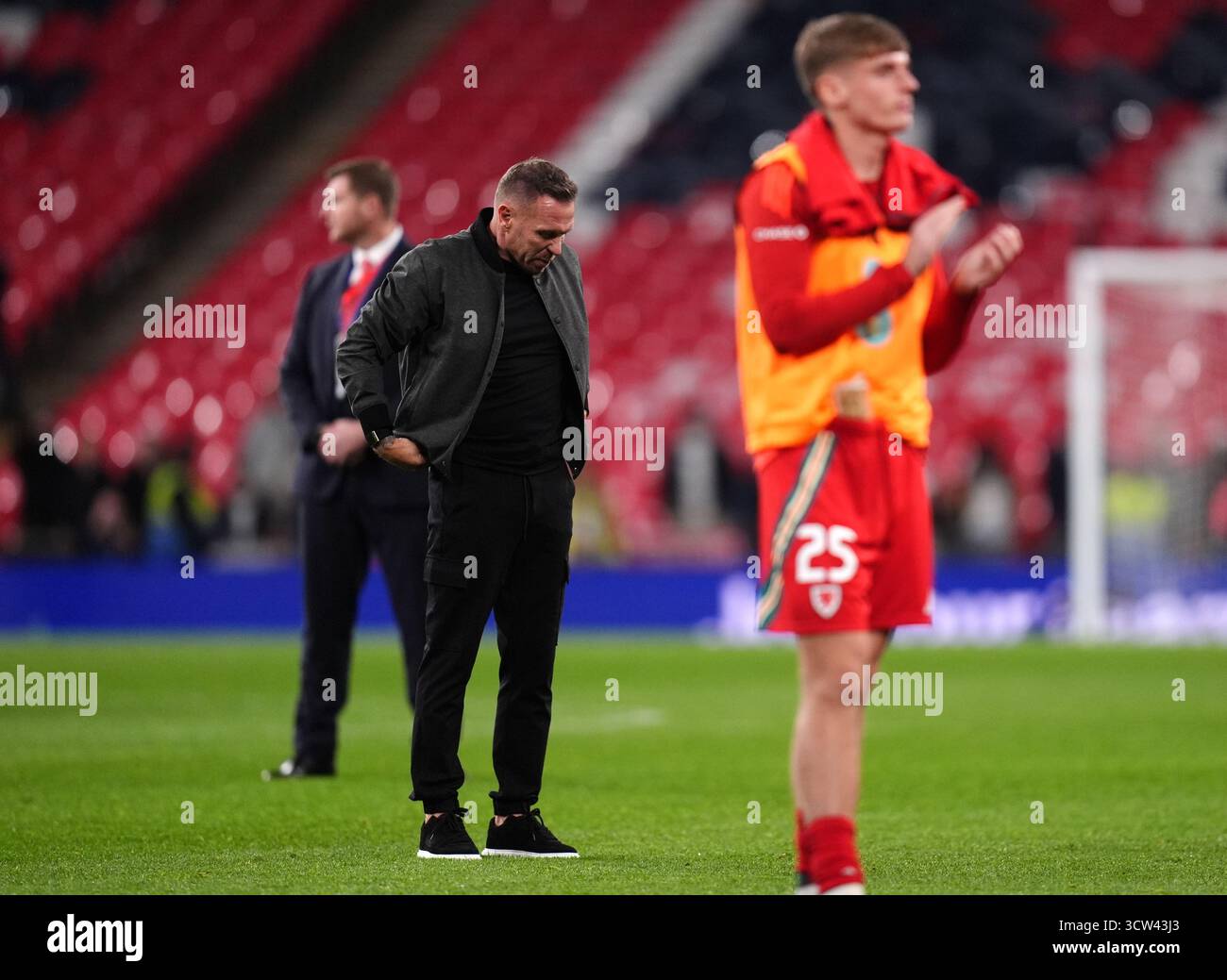 Wales manager Craig Bellamy (left) appears dejected after the ...