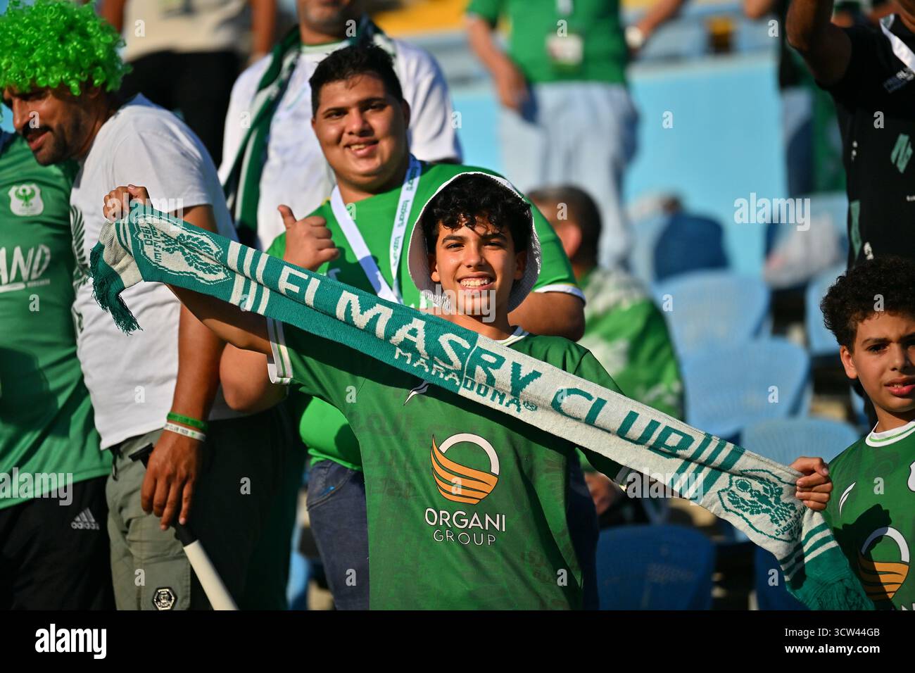 Al Masry SC fans cheer and wave flags during a football match at Suez ...