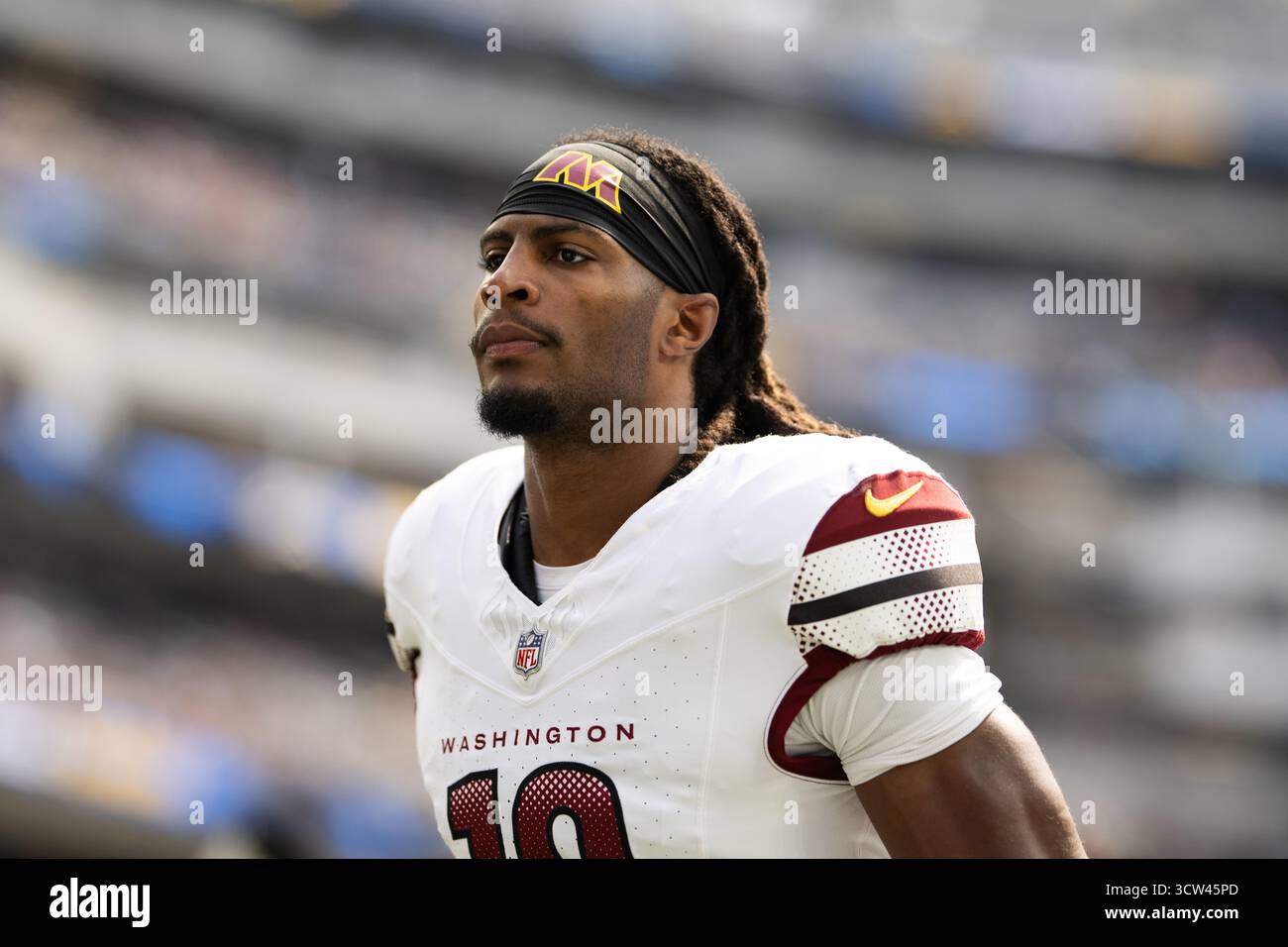 Washington Commanders safety Tyler Owens (18) walks back to the locker ...