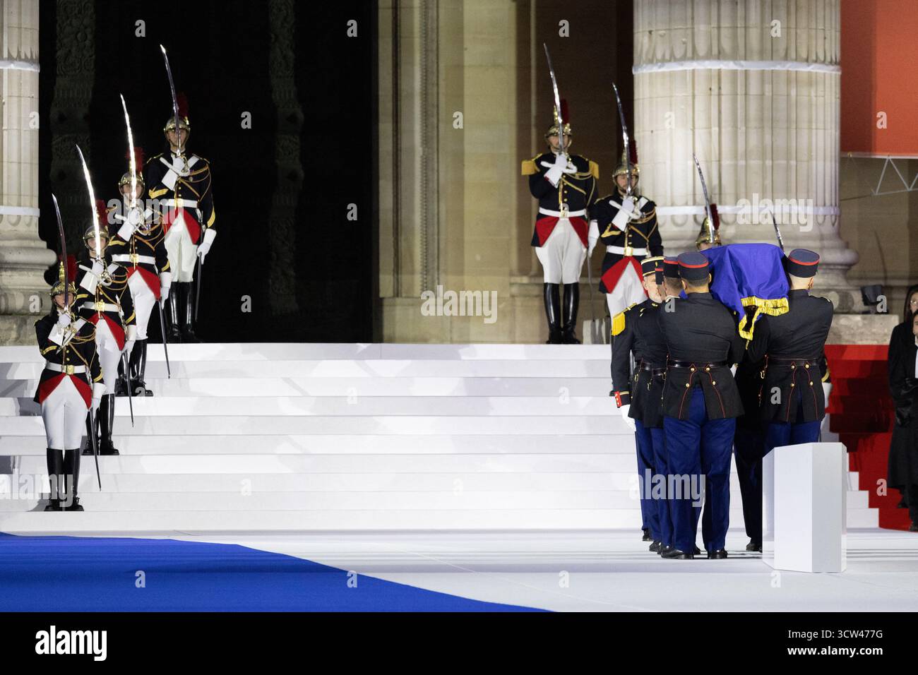 French Republican Guard carry a flag-draped ceremonial casket on rue ...