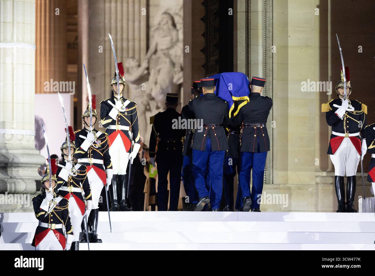French Republican Guard carry a flag-draped ceremonial casket on rue ...