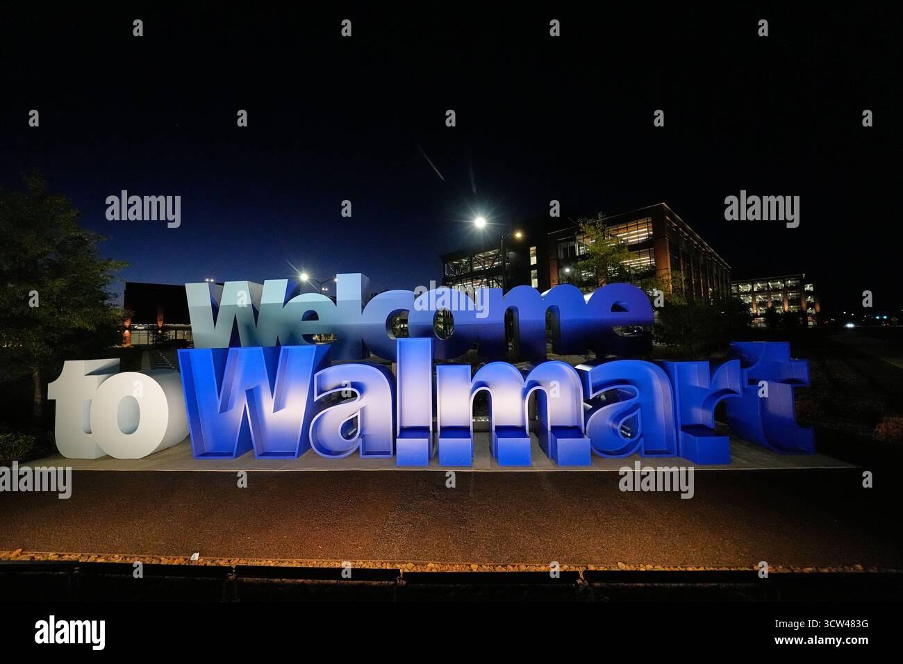 Office buildings are seen beyond a welcome sign at the Walmart home ...