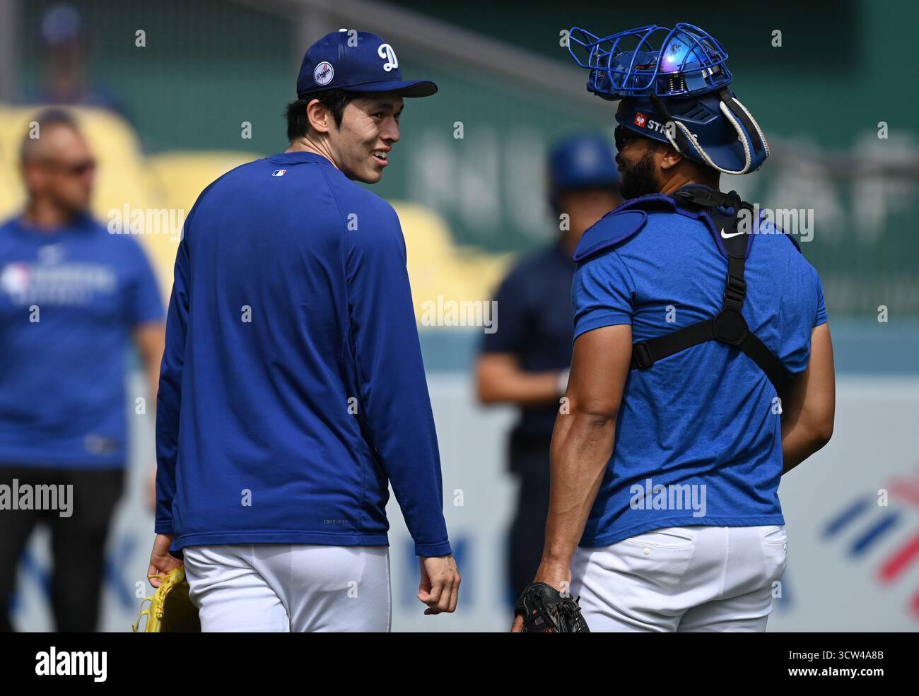 Los Angeles Dodgers' pitcher Roki Sasaki (L) takes part in practice ...
