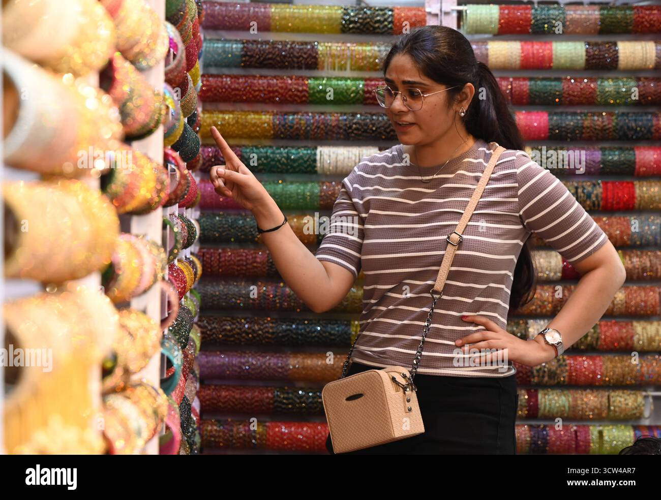 NEW DELHI, INDIA - OCTOBER 9: Women shop for bangles on the eve of Karva Chauth festival, at ...