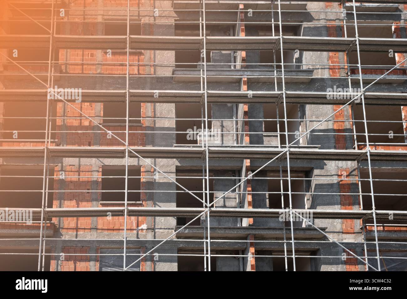 Construction scaffolding of multi-storey red brick building. the ...