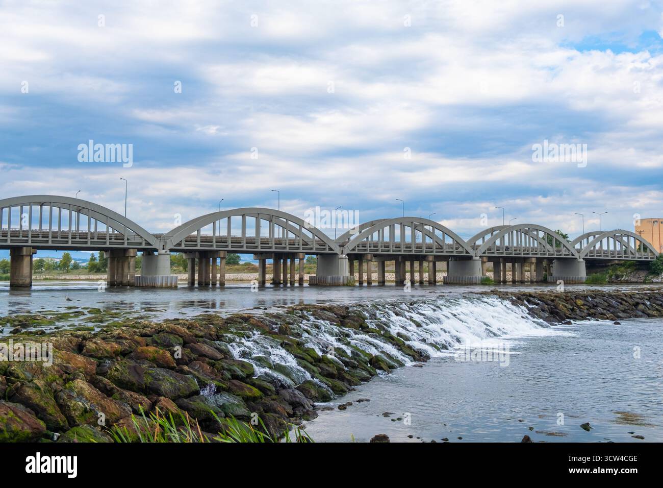 Landscape of the bridge over the river. River flowing with rocks under ...