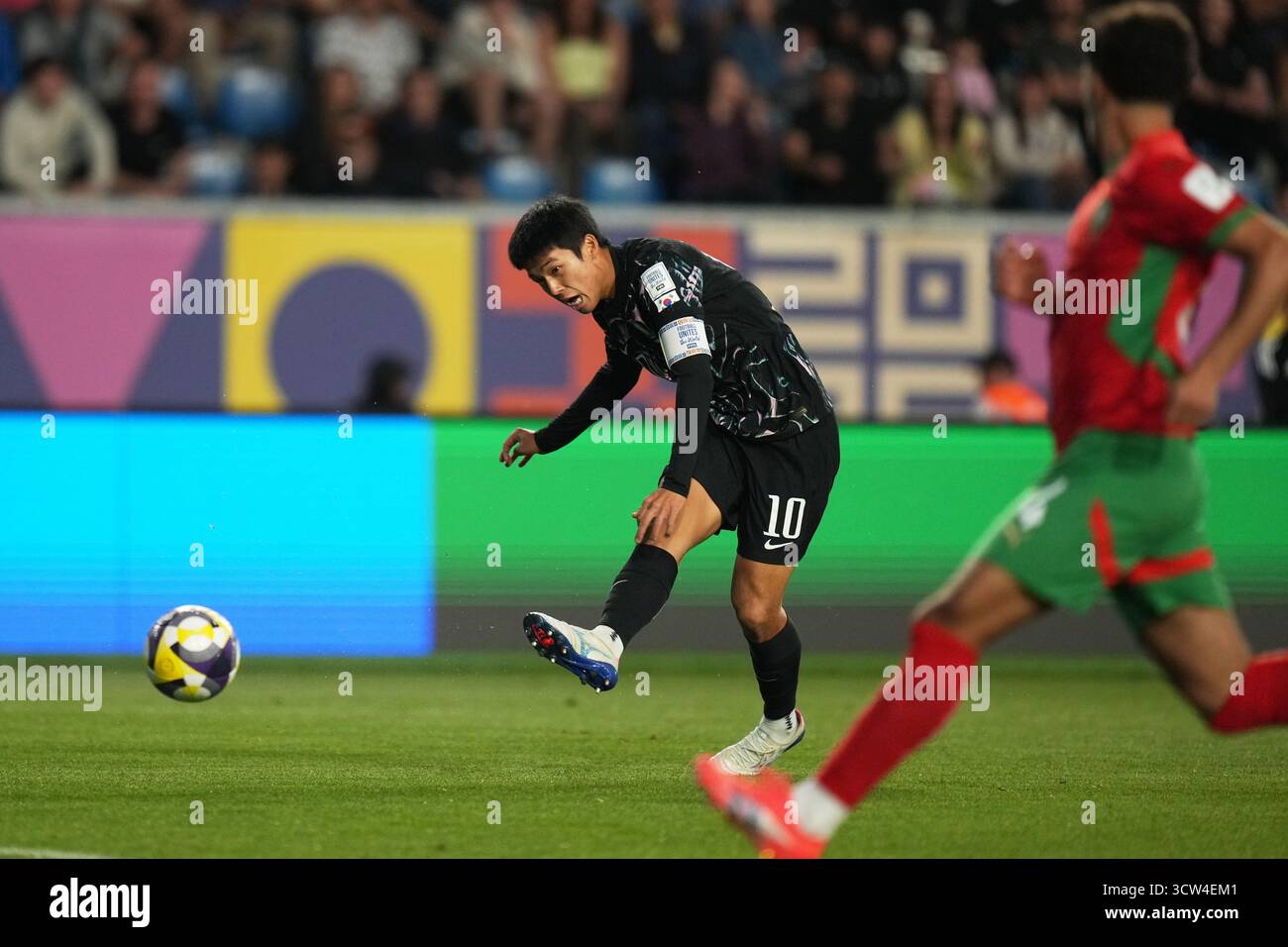 South Korea's Kim Tae-won, left, makes an attempt to score against ...