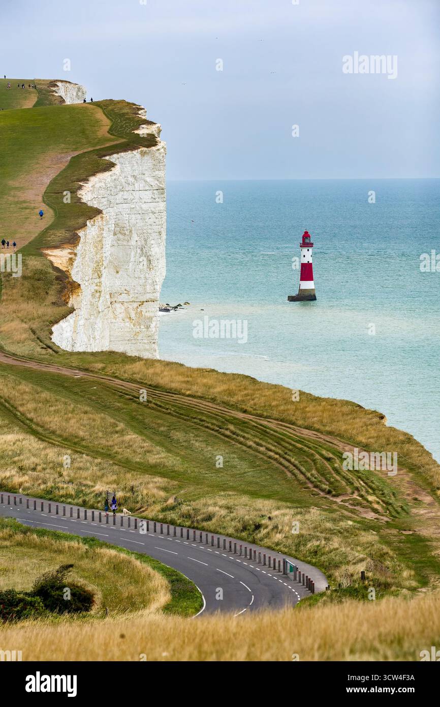 Beachy Head lighthouse below towering white chalk cliffs on the Sussex ...