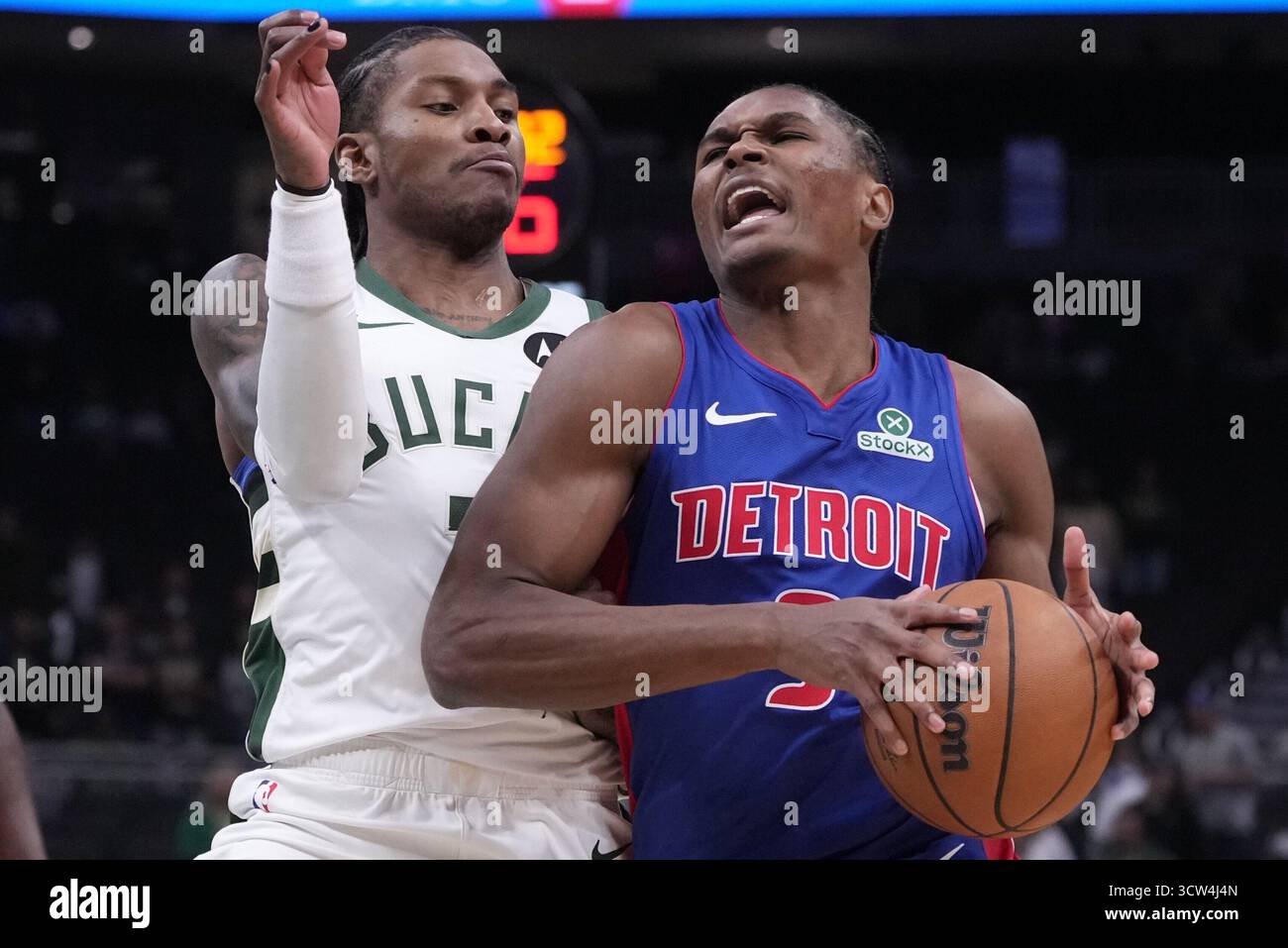 Detroit Pistons' Cade Cunningham drives by Milwaukee Bucks' Kevin ...