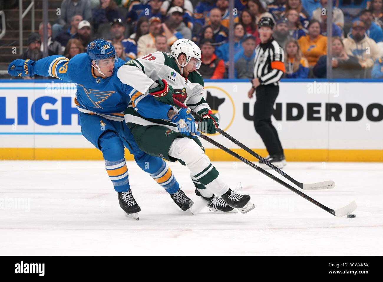 Minnesota Wild's Yakov Trenin, right, chases after a loose puck as St ...