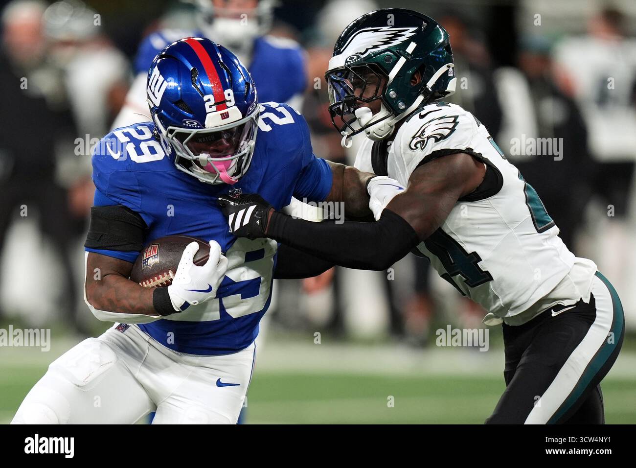 New York Giants' Tyrone Tracy Jr., left, tries to get past Philadelphia ...