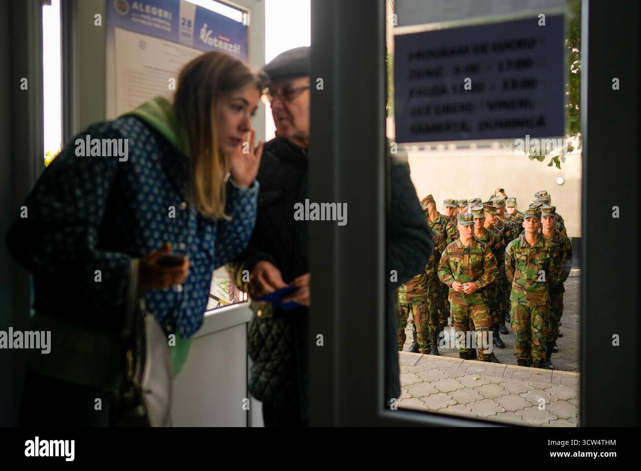 FILE - Soldiers wait outside a voting stations to cast their vote ...
