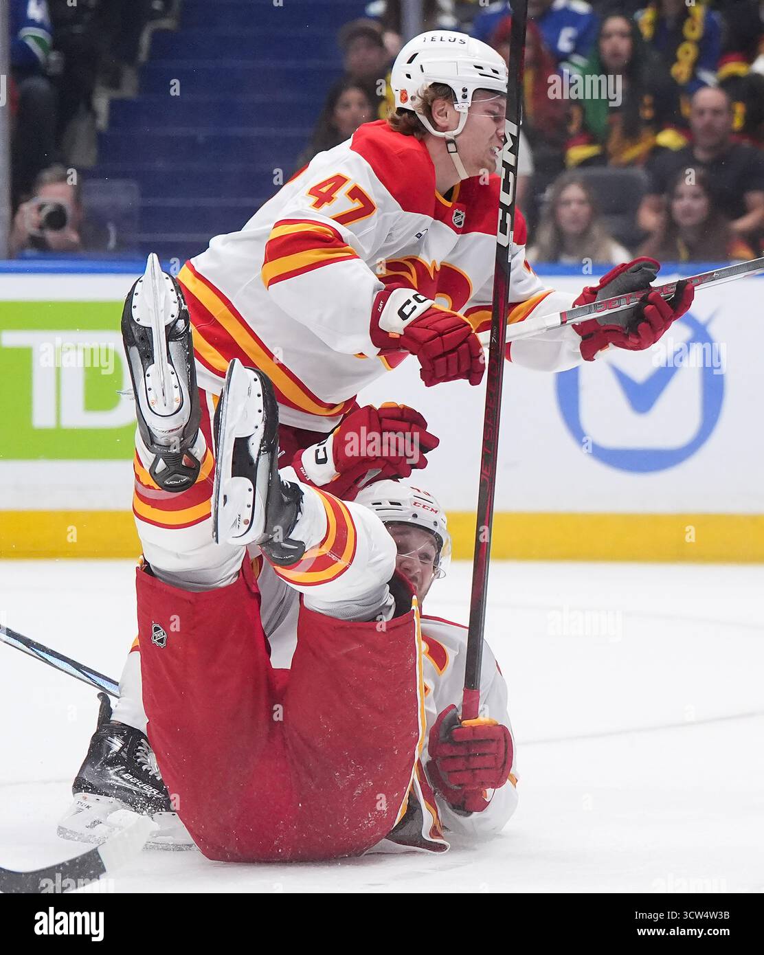 Calgary Flames' Connor Zary, top, collides with teammate Adam Klapka ...