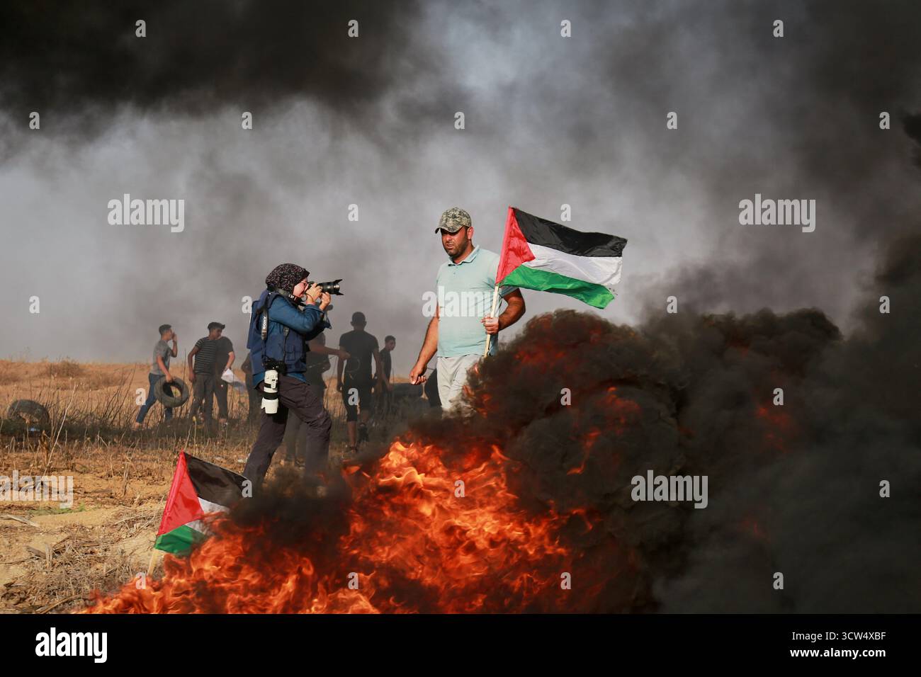 Associated Press photographer Fatima Shbair takes pictures during a ...