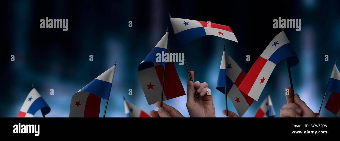 Panama flags in their hands on a blurred urban background Stock Photo ...