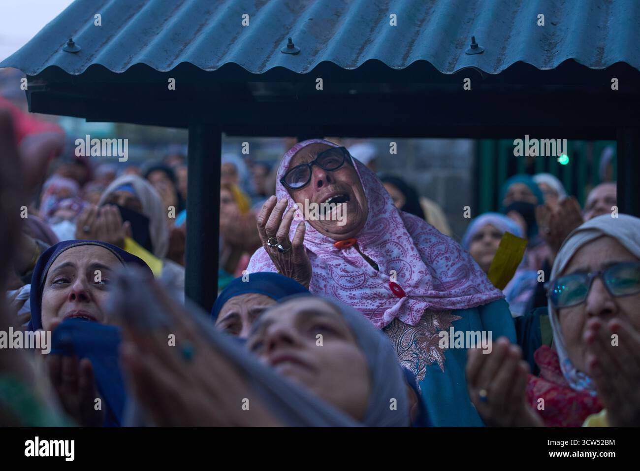 Kashmiri Muslims pray as a priest displays a relic of Sufi saint Sheikh ...