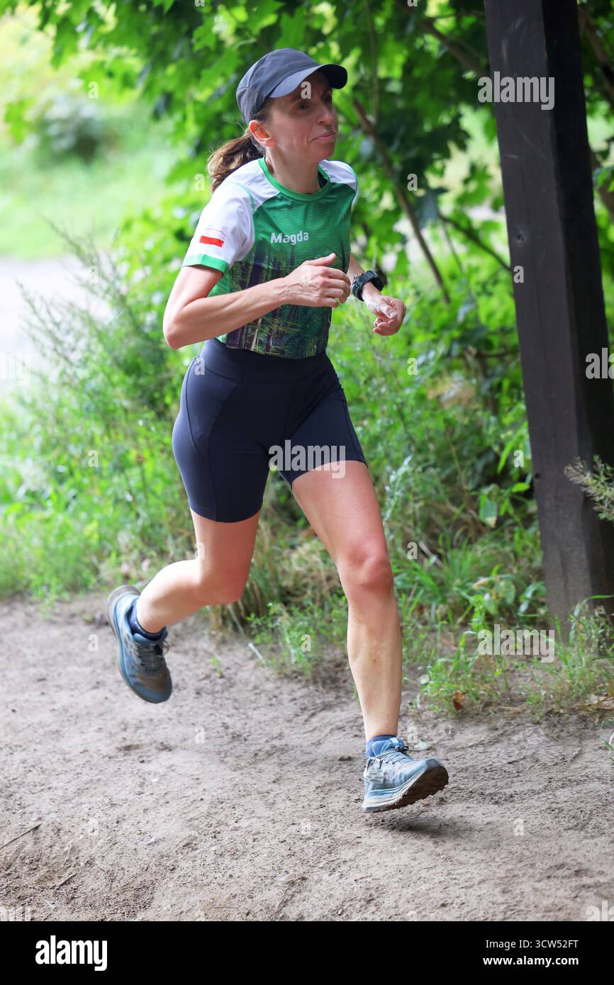 Female Runner in Action on a Forest Trail Stock Photo - Alamy